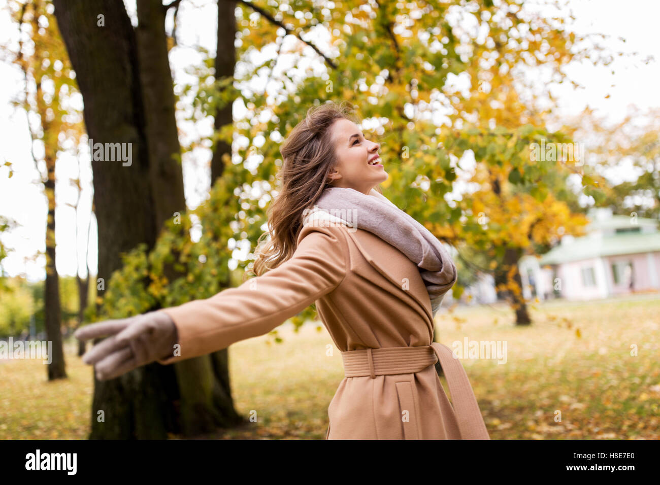 beautiful happy young woman walking in autumn park Stock Photo - Alamy
