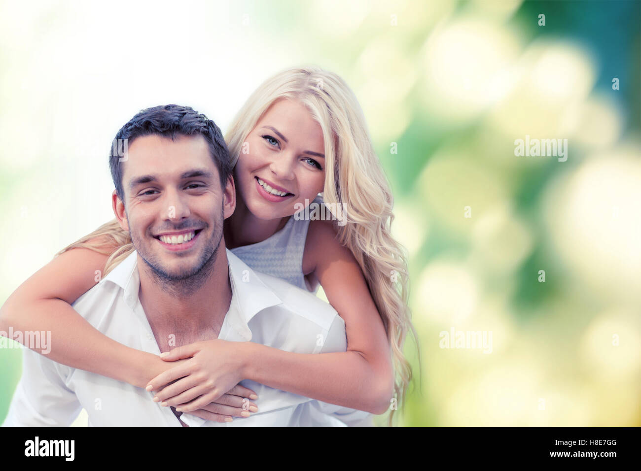 happy couple having fun over green background Stock Photo - Alamy