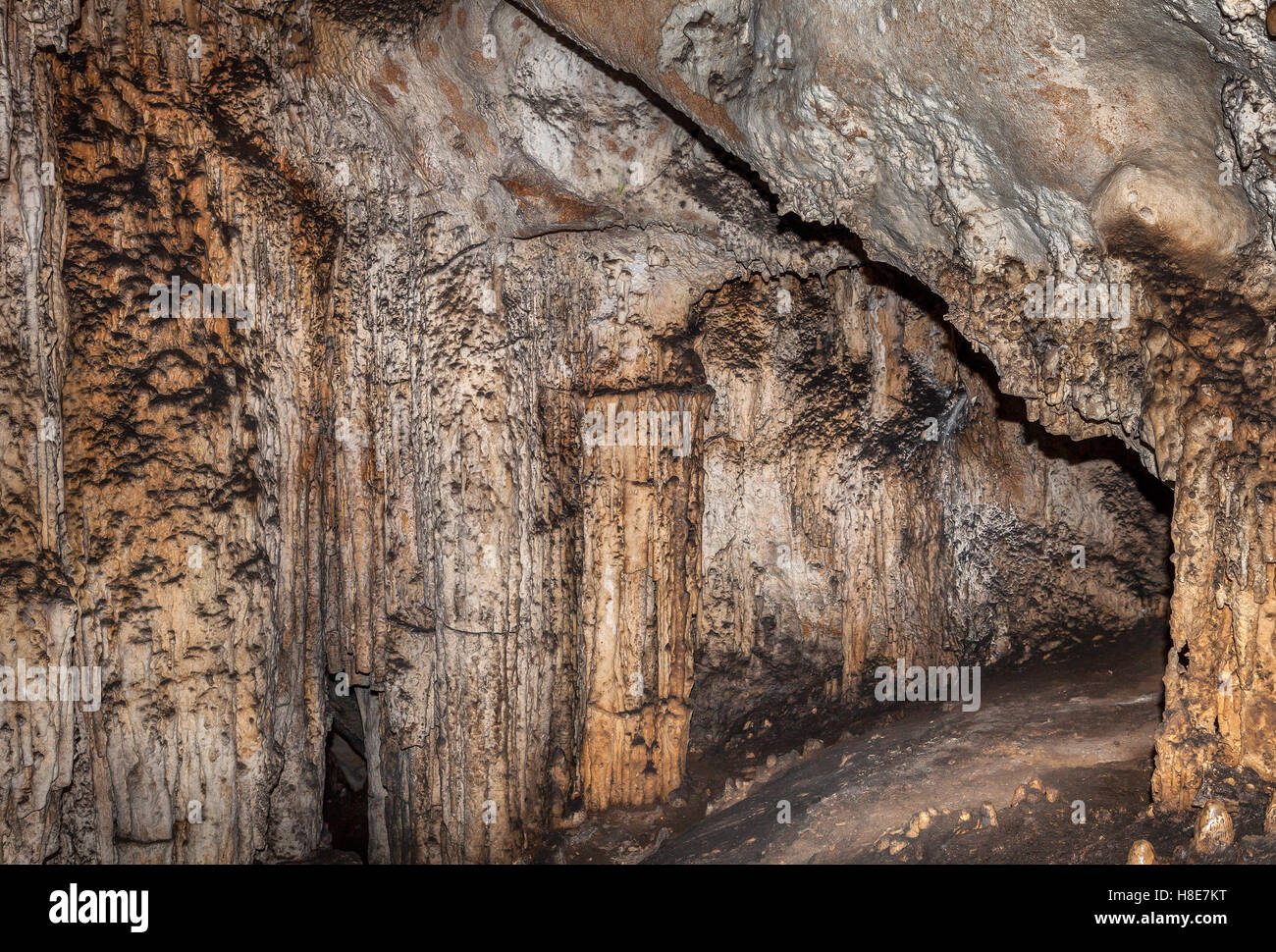 Passage in a deep cave. A stone block wall Stock Photo - Alamy
