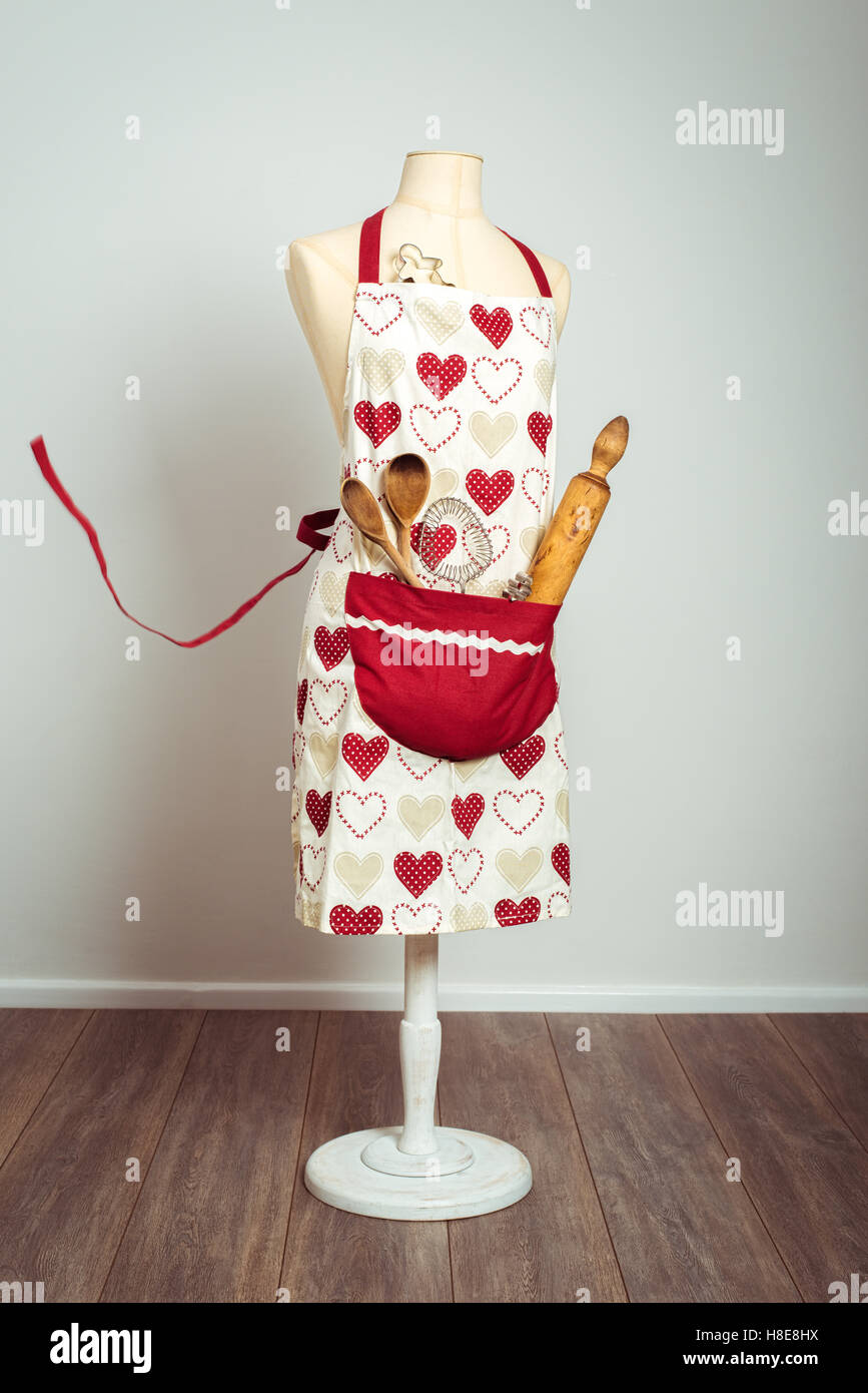 Red apron with pocket filled with utensils Stock Photo - Alamy