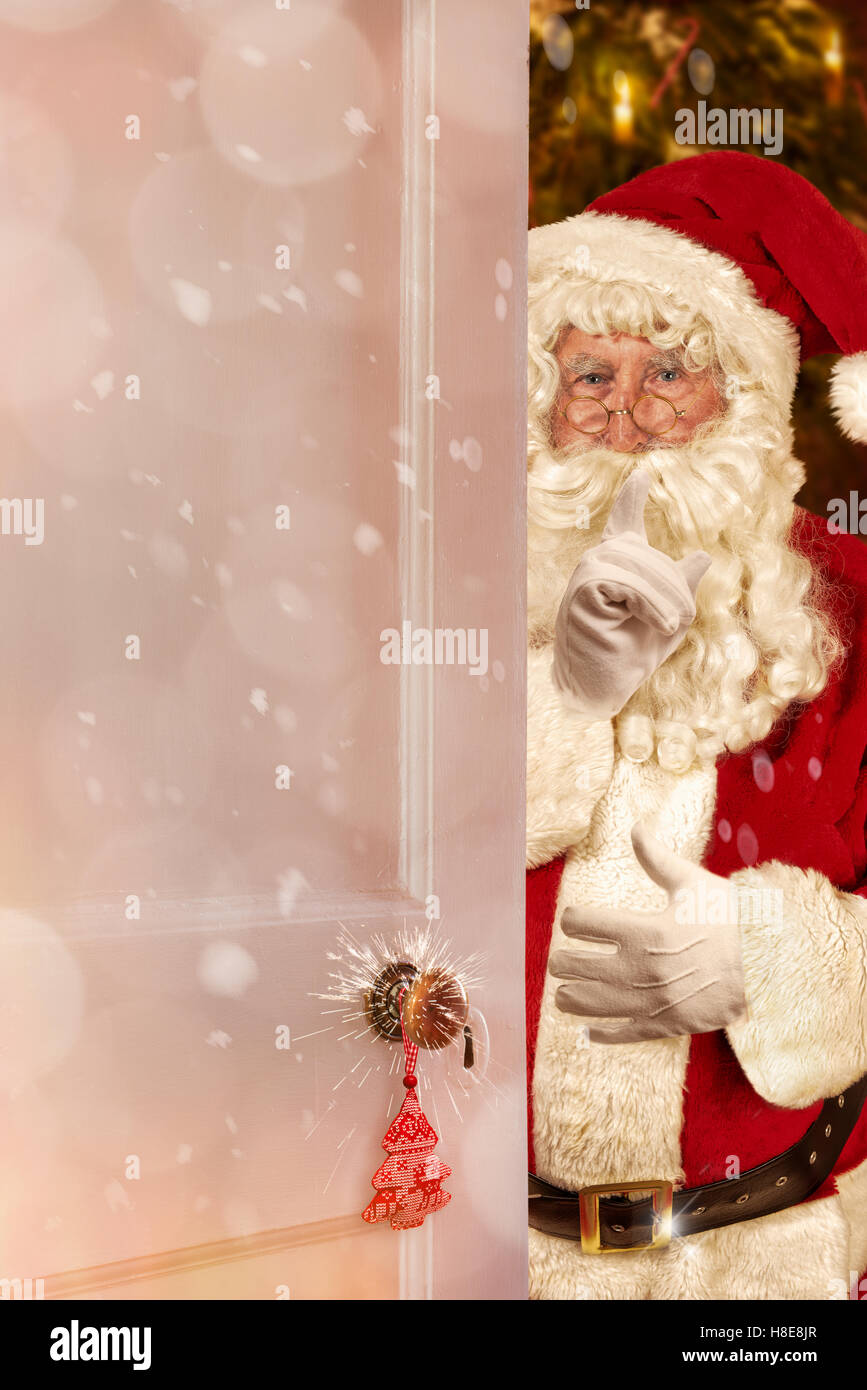Santa Claus at an open Christmas door Stock Photo - Alamy
