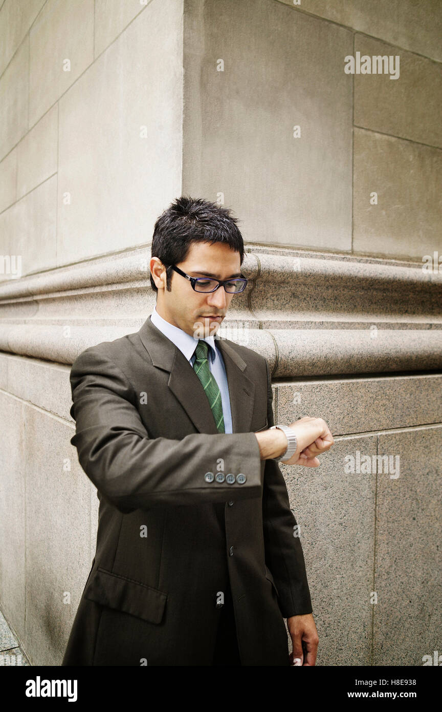 Businessman checking his watch Stock Photo - Alamy