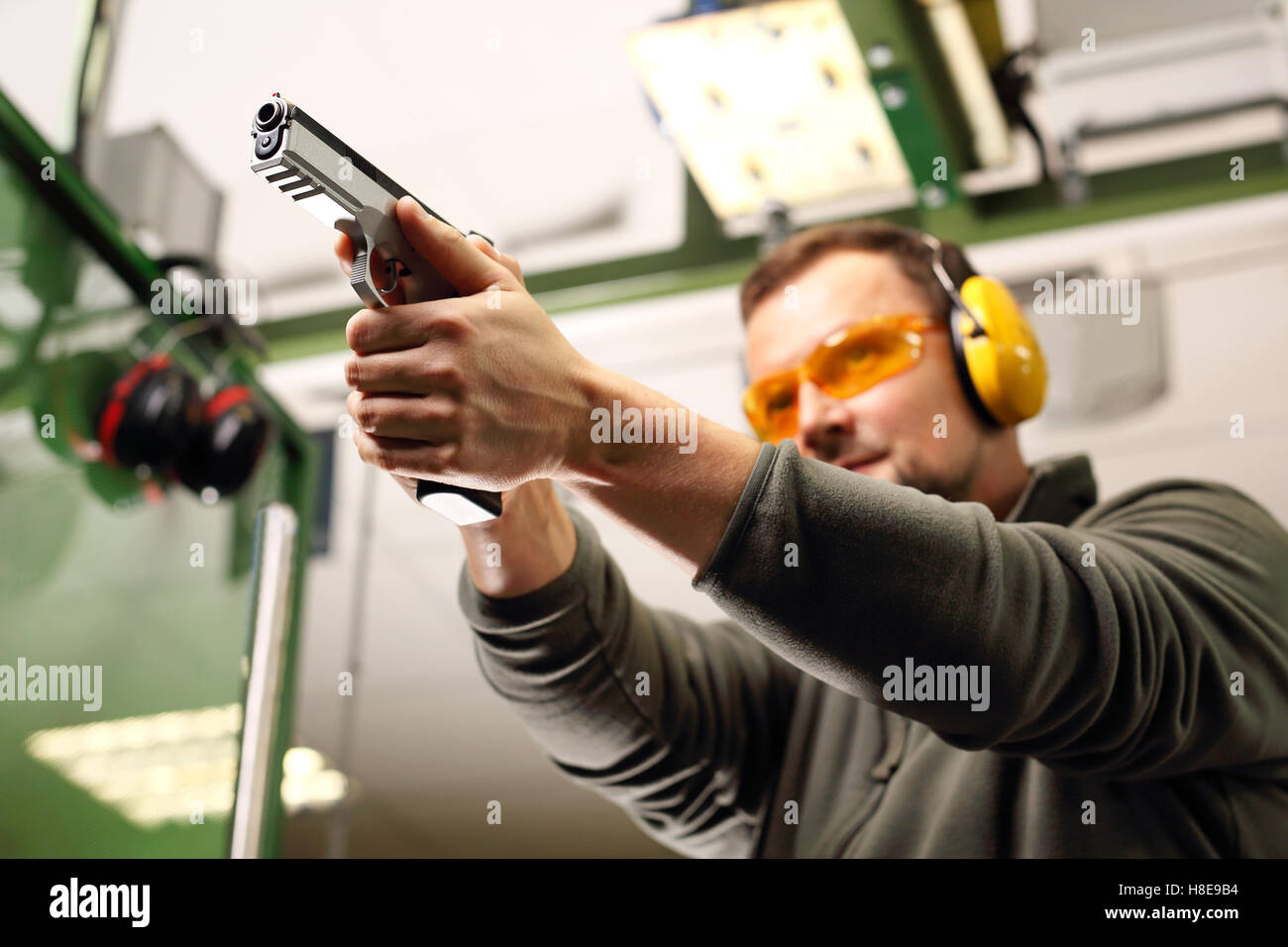 Shooting a gun at a shooting range Stock Photo - Alamy