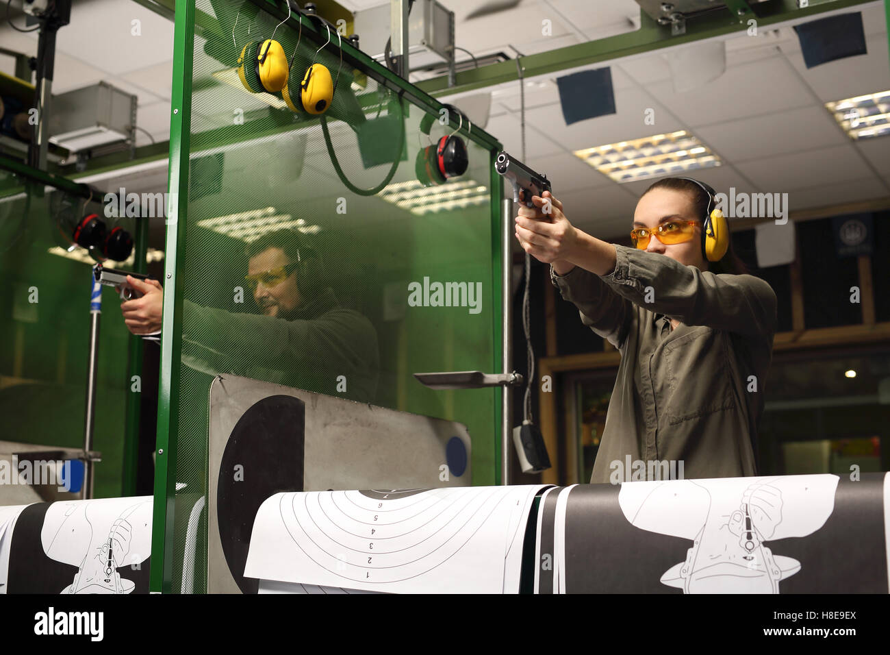 Self-defense, the woman at the shooting range. The woman aiming a gun ...
