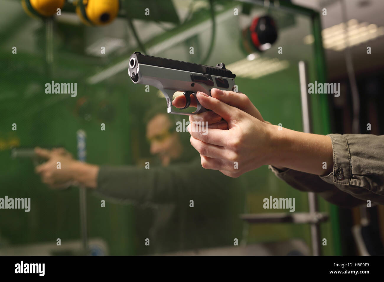 Self-defense, the woman at the shooting range. The woman aiming a gun ...