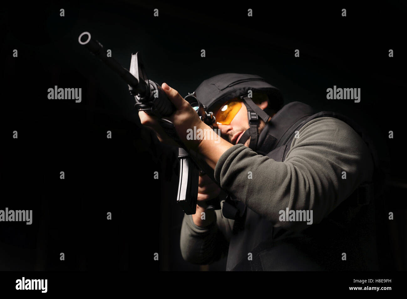 A man with a gun wearing a bulletproof vest and helmet. Antiterrorist ...