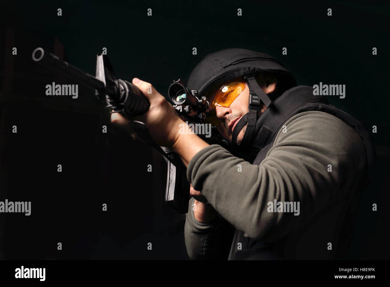 A man with a gun wearing a bulletproof vest and helmet. Antiterrorist ...