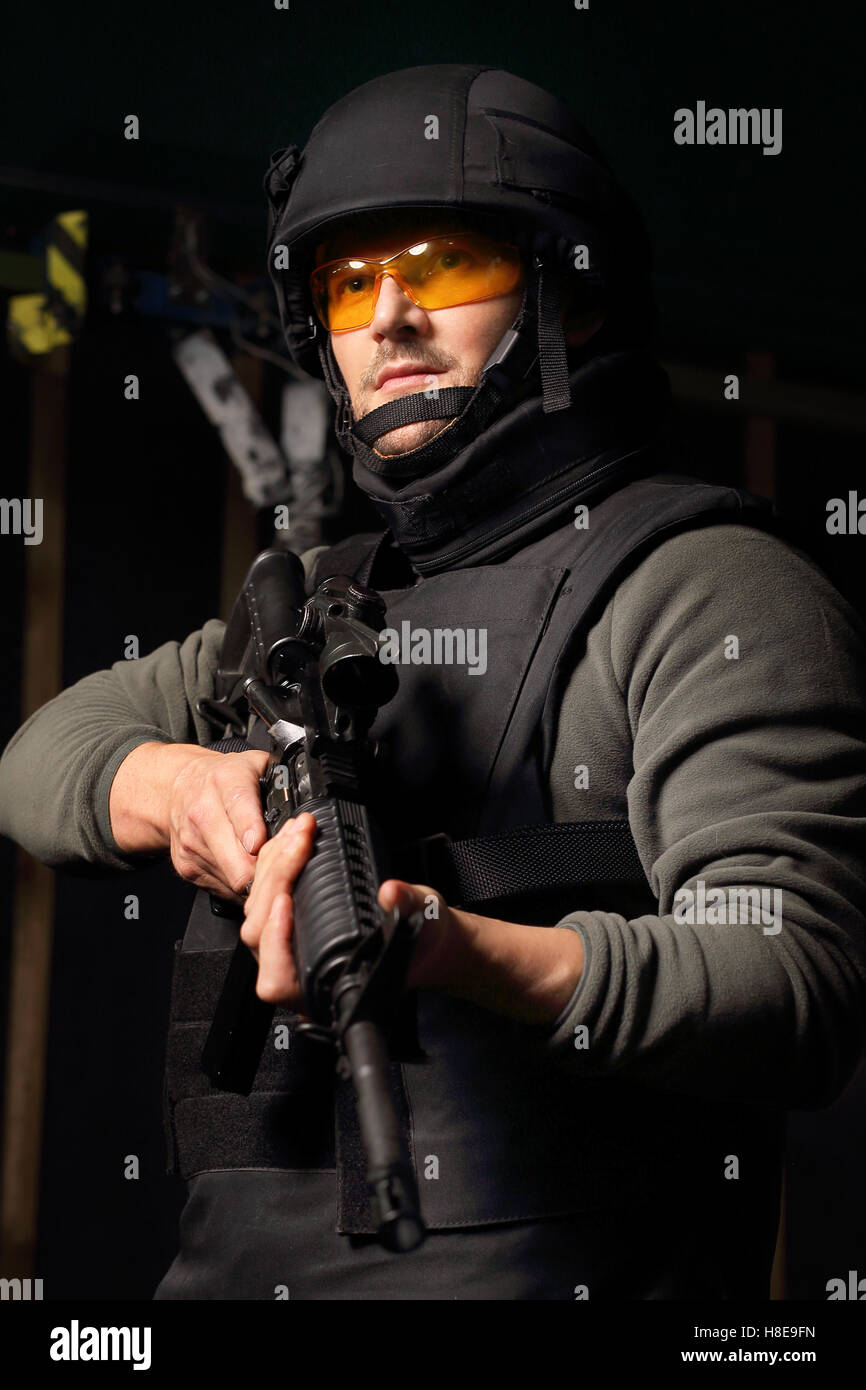 Military. A man with a gun wearing a bulletproof vest and helmet Stock ...