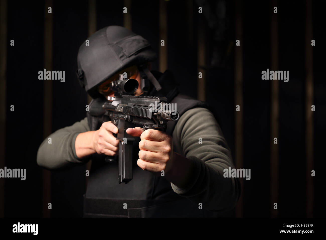 Military. A man with a gun wearing a bulletproof vest and helmet Stock ...