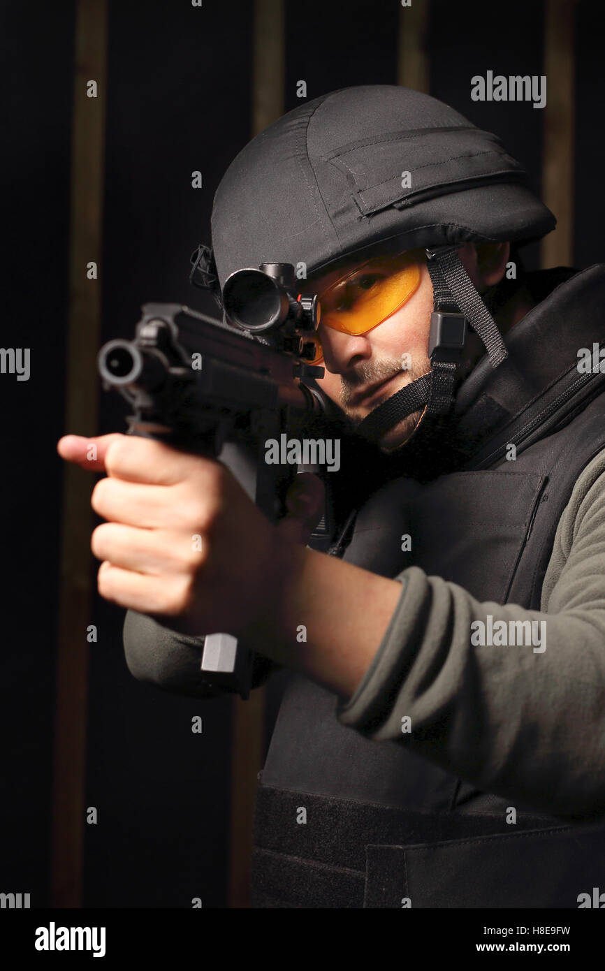 Military. A man with a gun wearing a bulletproof vest and helmet Stock ...