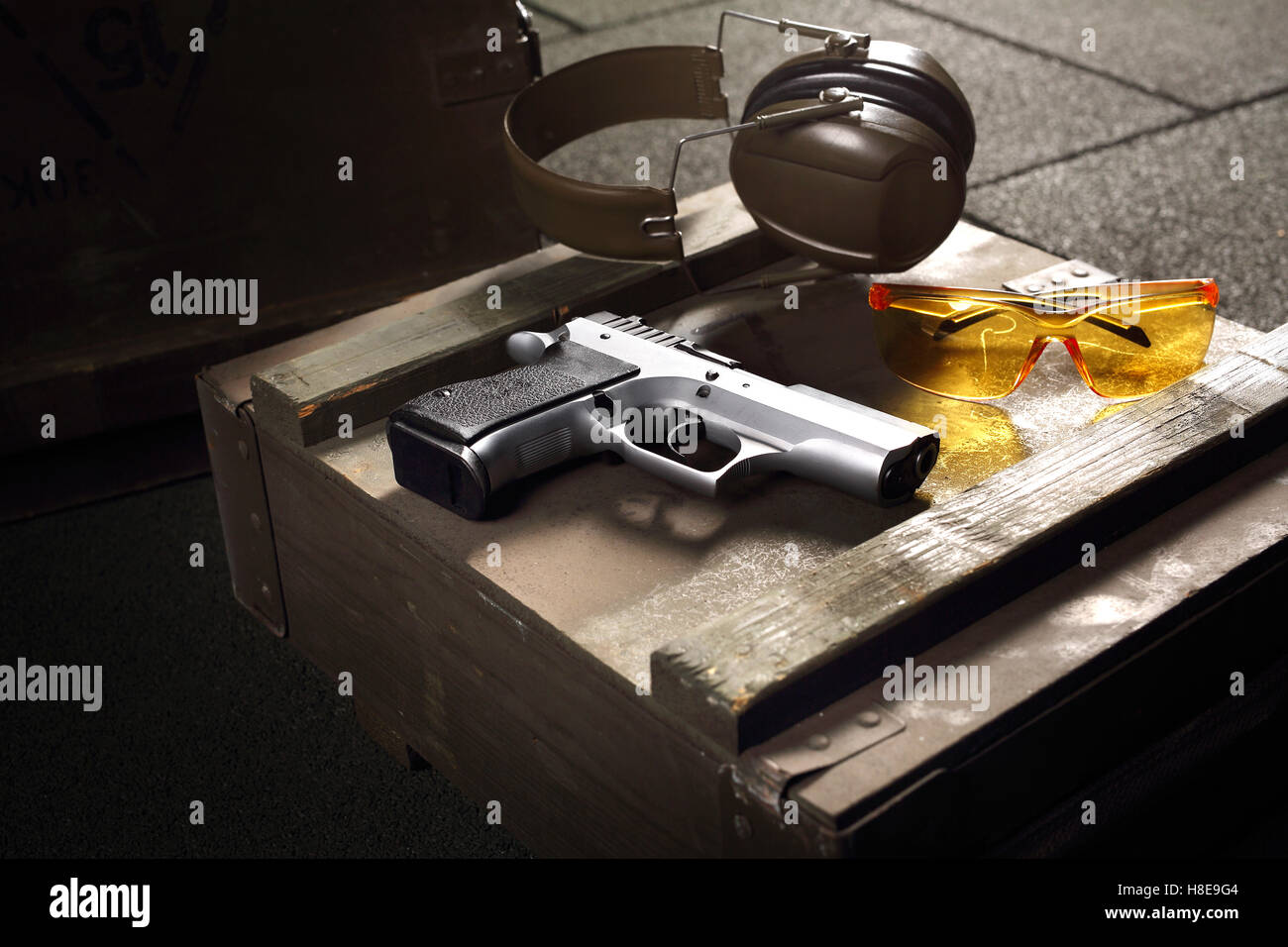 Handgun, pistol. Equipment shooting gun. Gun, cartridges and headphones ...