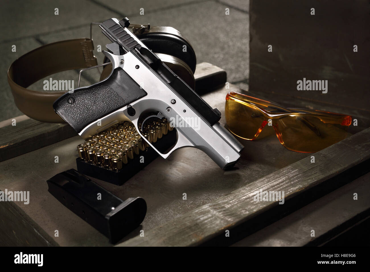 Handgun, pistol. Equipment shooting gun. Gun, cartridges and headphones ...