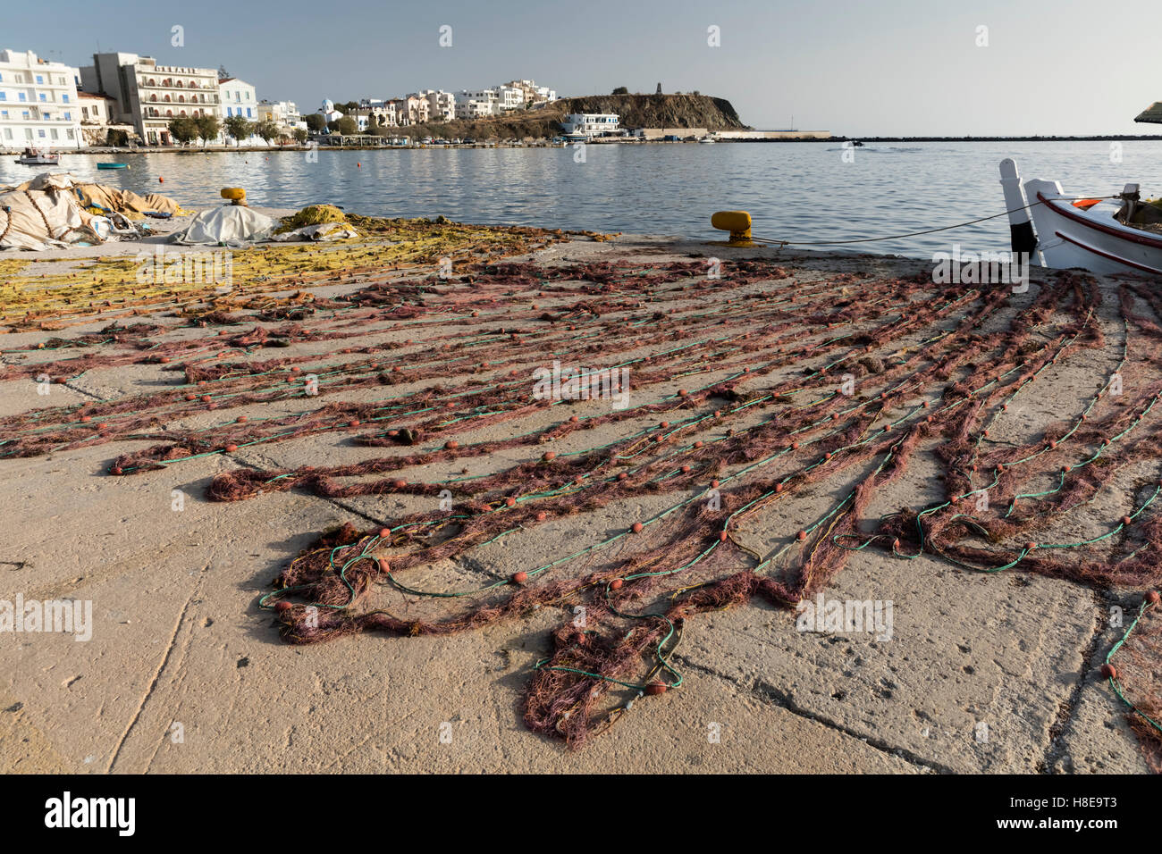 Fishing nets spread out on pier to dry, Chora town, Tinos in the Greek ...