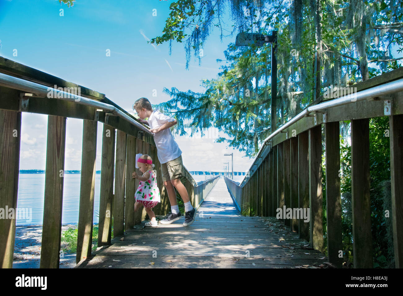 Kids on dock Stock Photo - Alamy