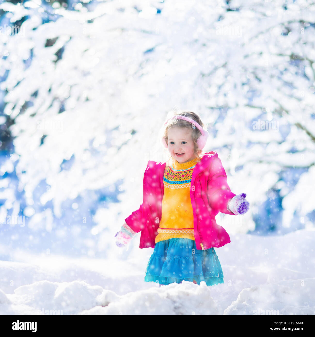 Little girl enjoying a sleigh ride. Child sledding. Toddler kid riding ...