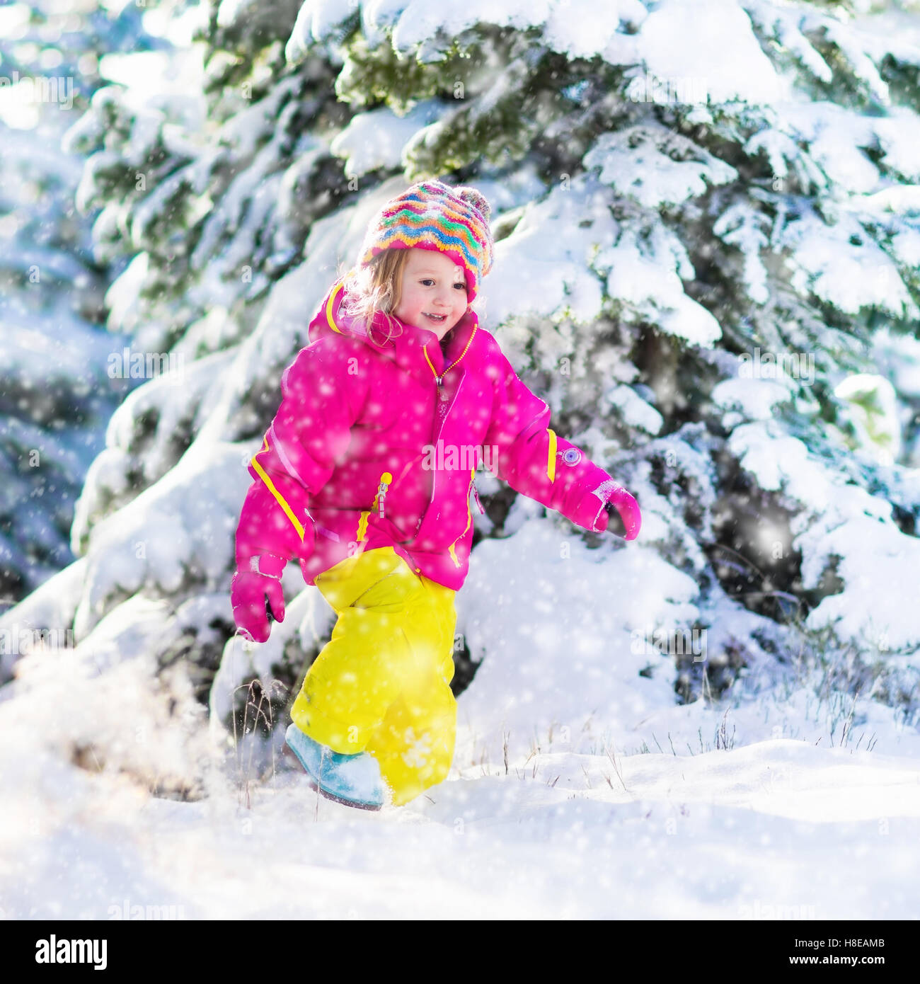 Little girl enjoying a sleigh ride. Child sledding. Toddler kid riding ...