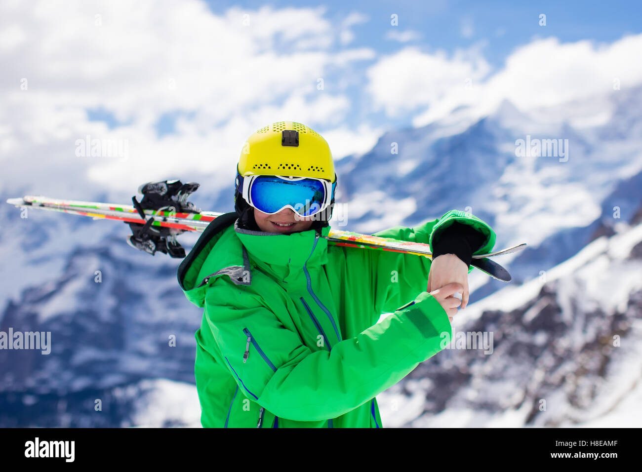 Child skiing in mountains. Active teenager kid with safety helmet ...