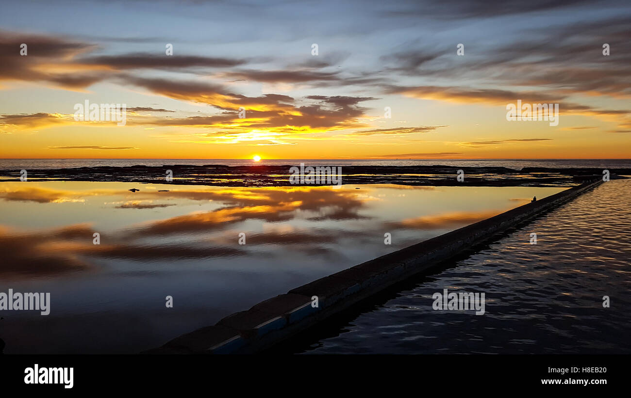 Sunrise over rock pool Stock Photo - Alamy