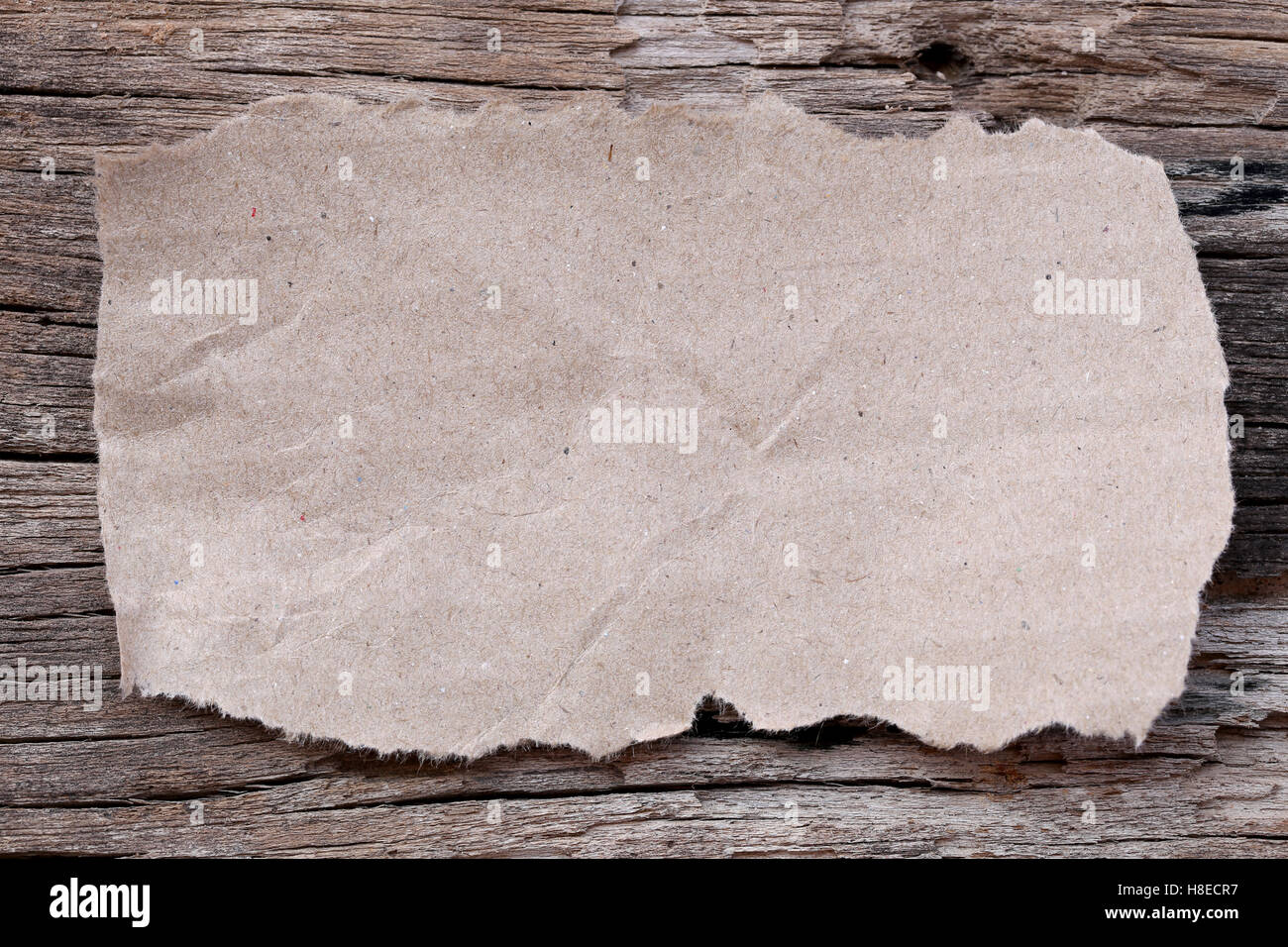 Brown tear cardboard on old wooden floor concepts about education or ...