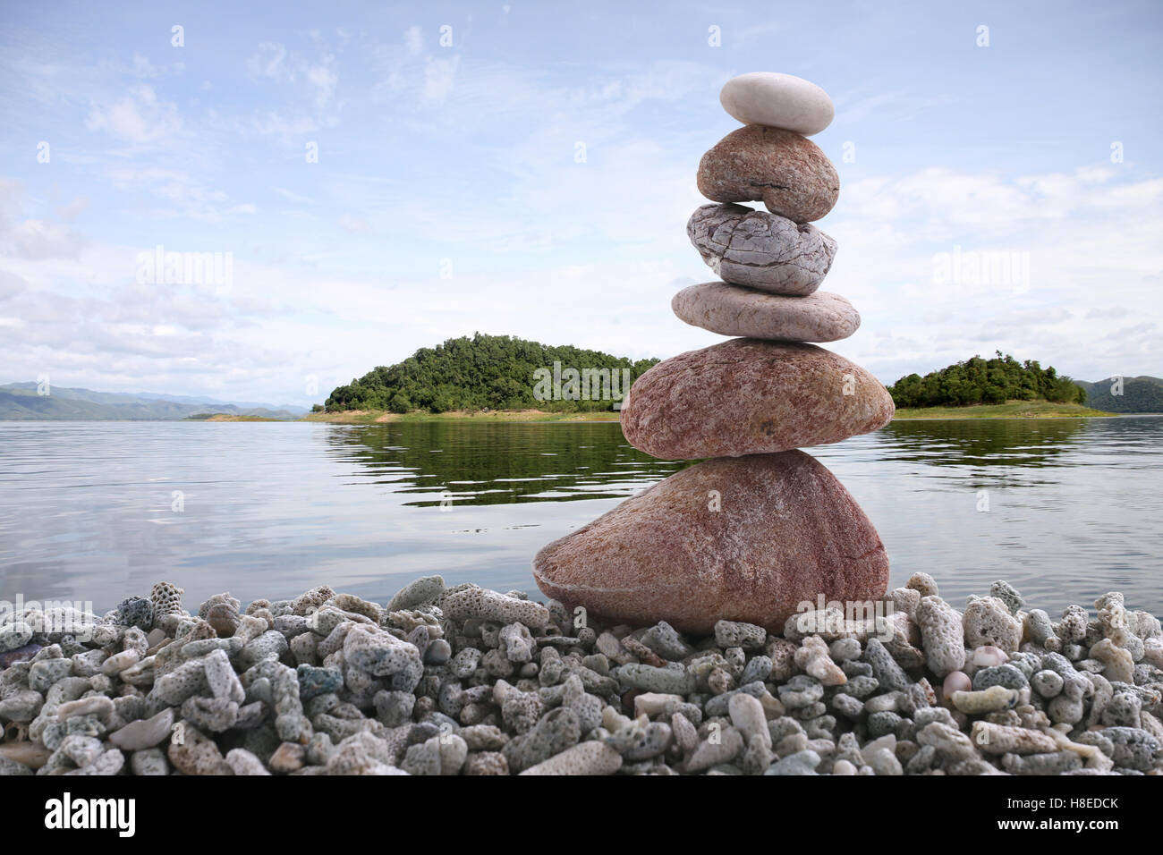 Balance stone on pile rock with river background for concept of Zen and ...
