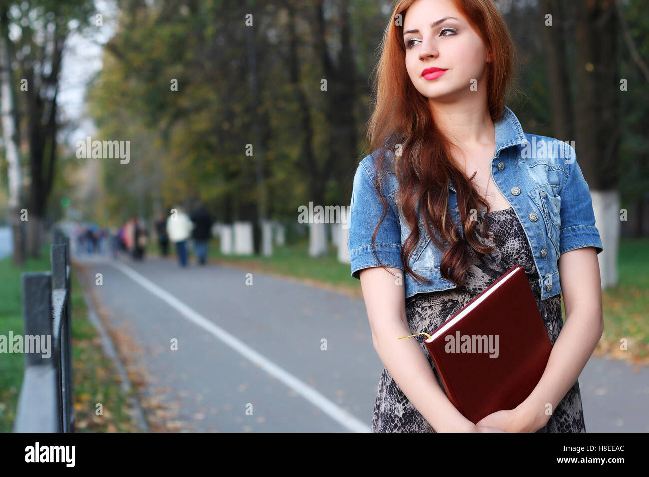red-haired girl dress folder with documents Stock Photo - Alamy