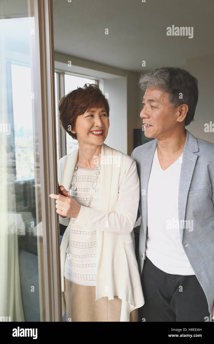 Fashionable Japanese senior couple by the window Stock Photo - Alamy