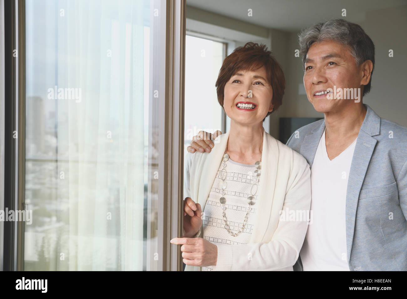 Fashionable Japanese senior couple by the window Stock Photo - Alamy