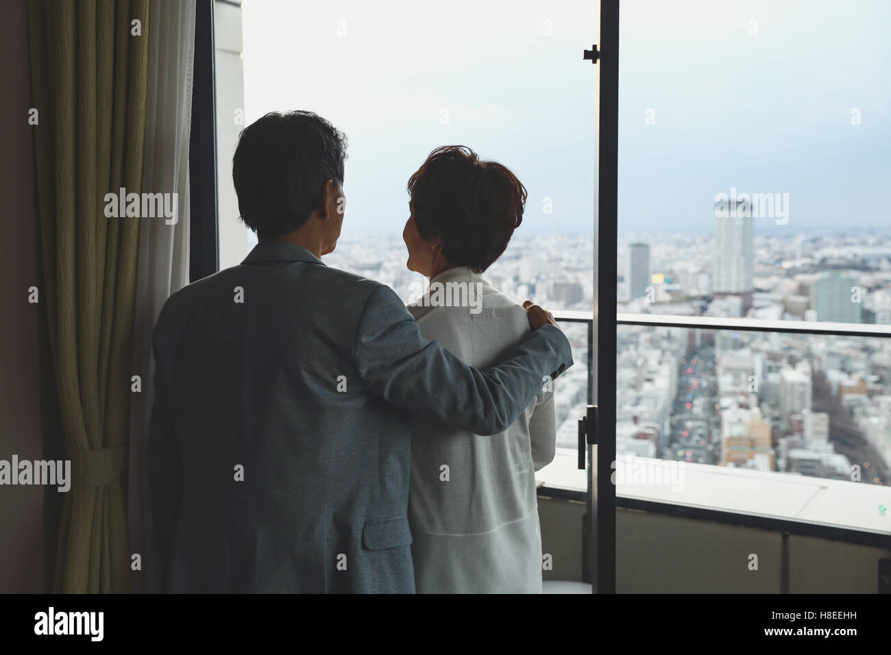 Fashionable Japanese senior couple by the window Stock Photo - Alamy