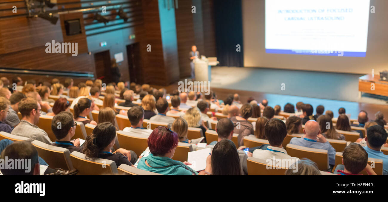 Business speaker giving a talk in conference hall Stock Photo - Alamy
