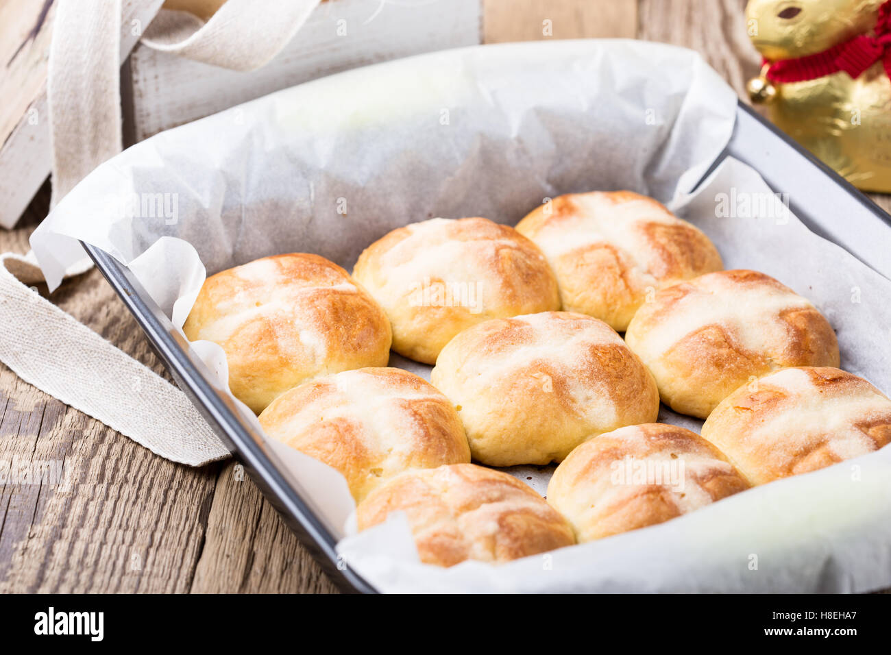 Homemade Easter hot cross buns in bakery tray on wooden table Stock ...