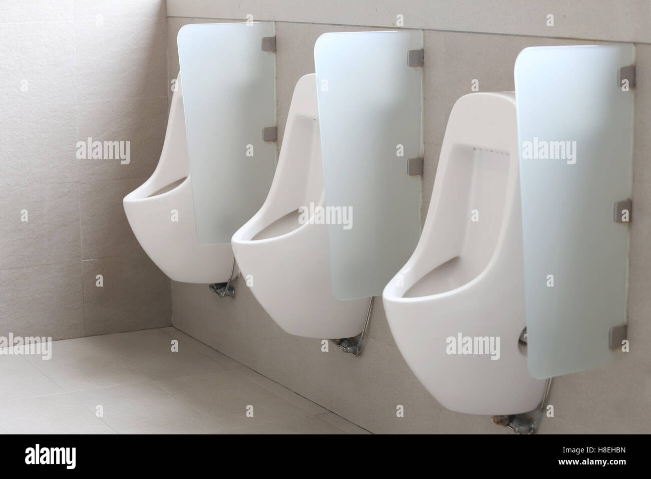 Modern urinal in men bathroom, white ceramic urinals for men in toilet ...