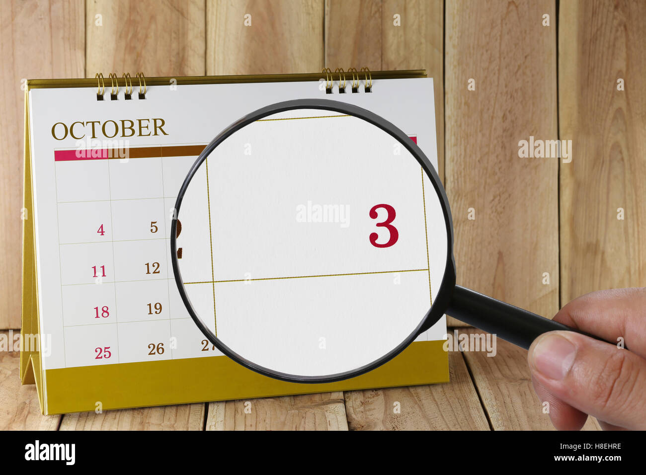 Magnifying glass in hand on calendar you can look third date of month ...