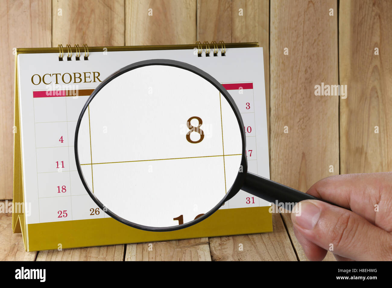 Magnifying glass in hand on calendar you can look eighth date of month ...