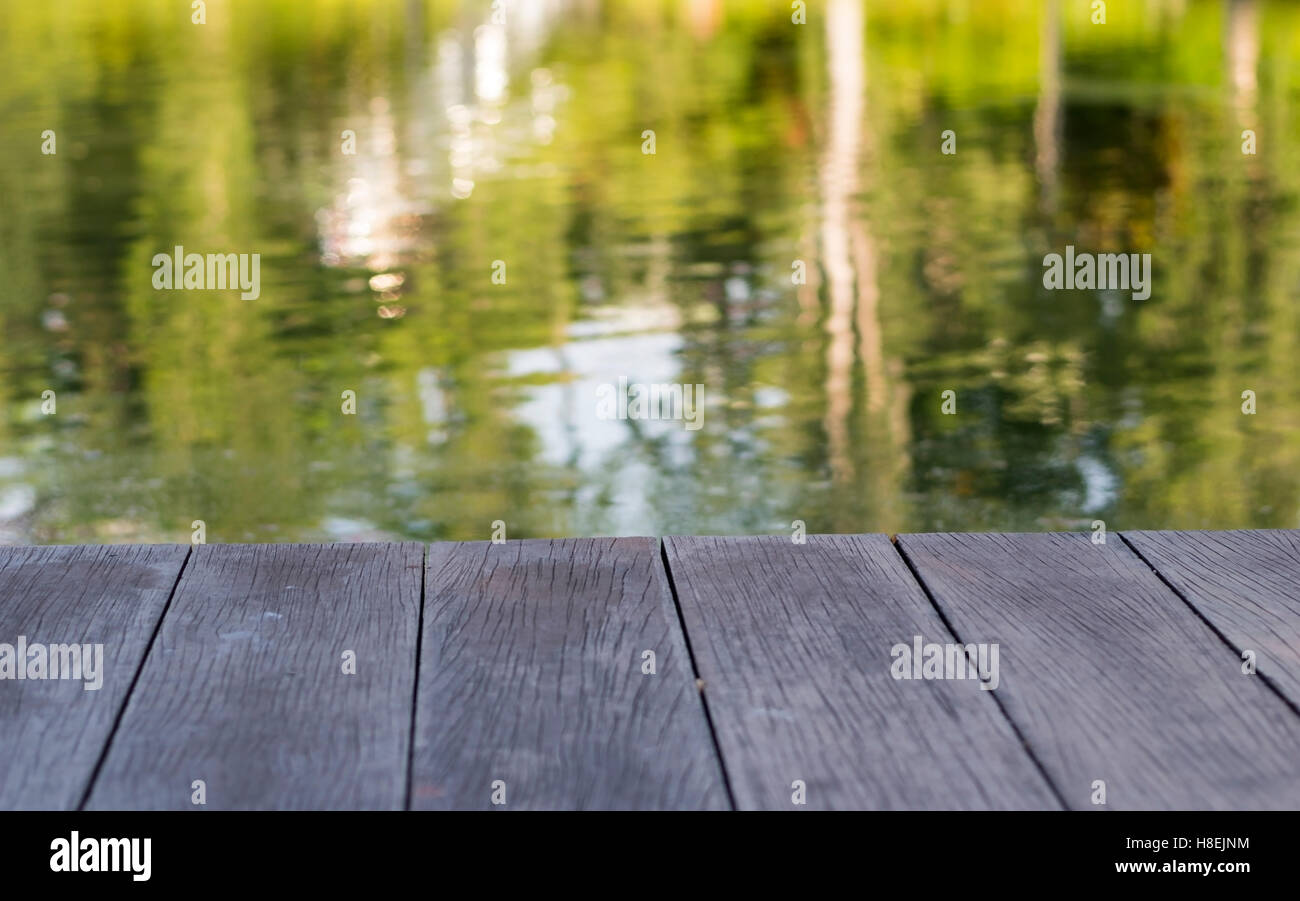 wooden table in front of blurred background of river Stock Photo - Alamy