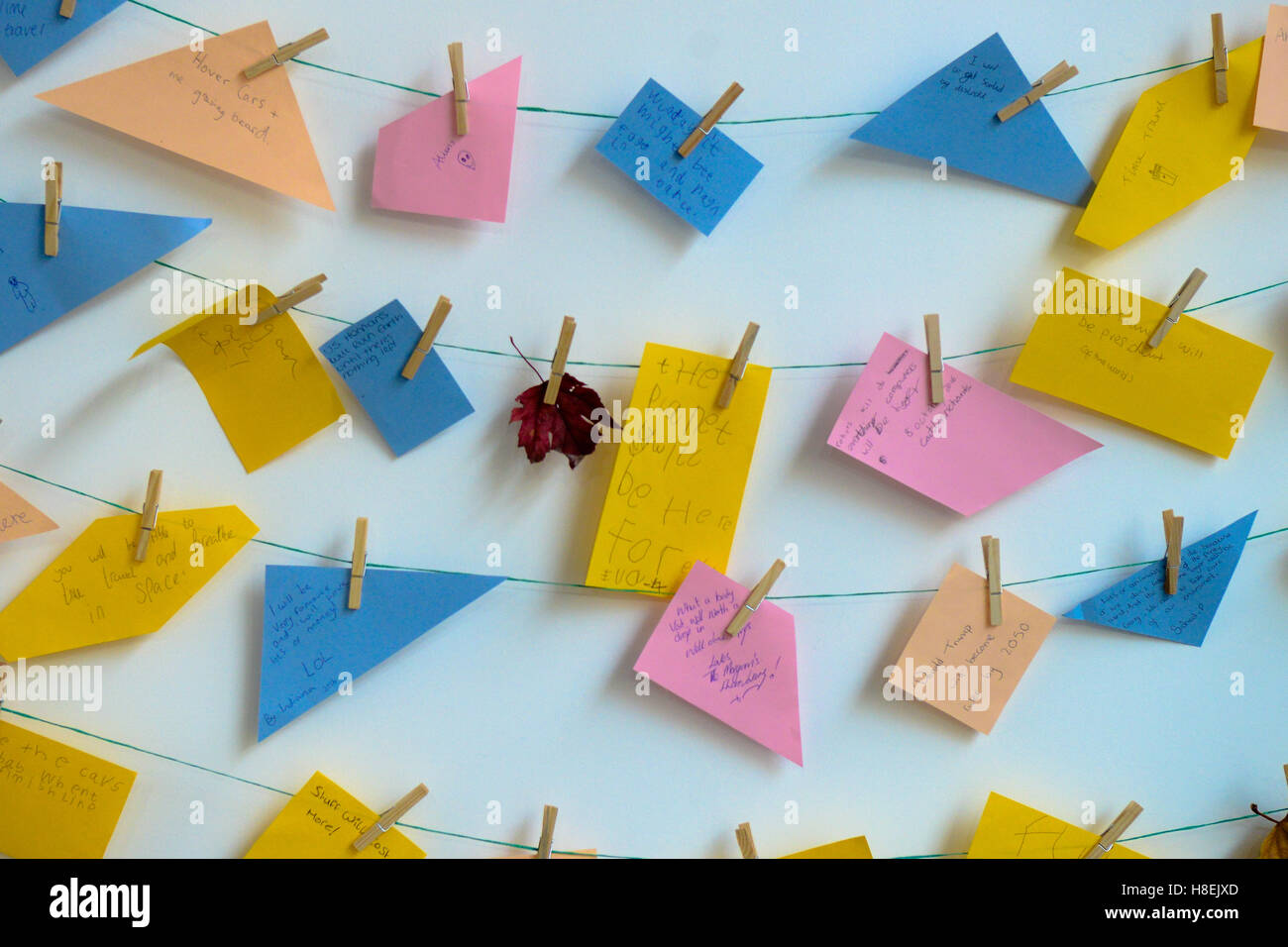 Post-it notes in children's handwriting pegged on string along with ...
