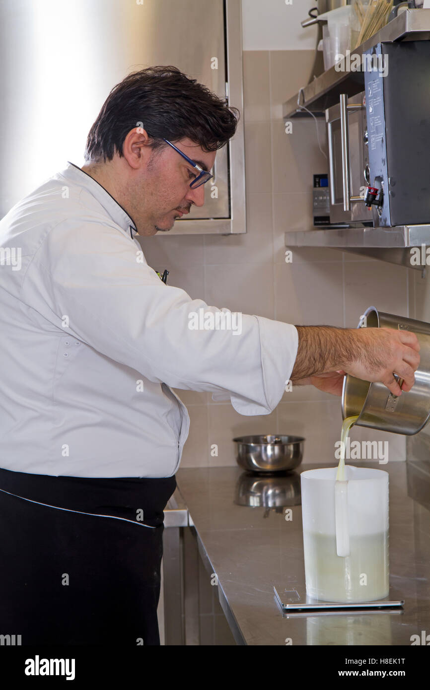 cook working in a kitchen restaurant Stock Photo - Alamy