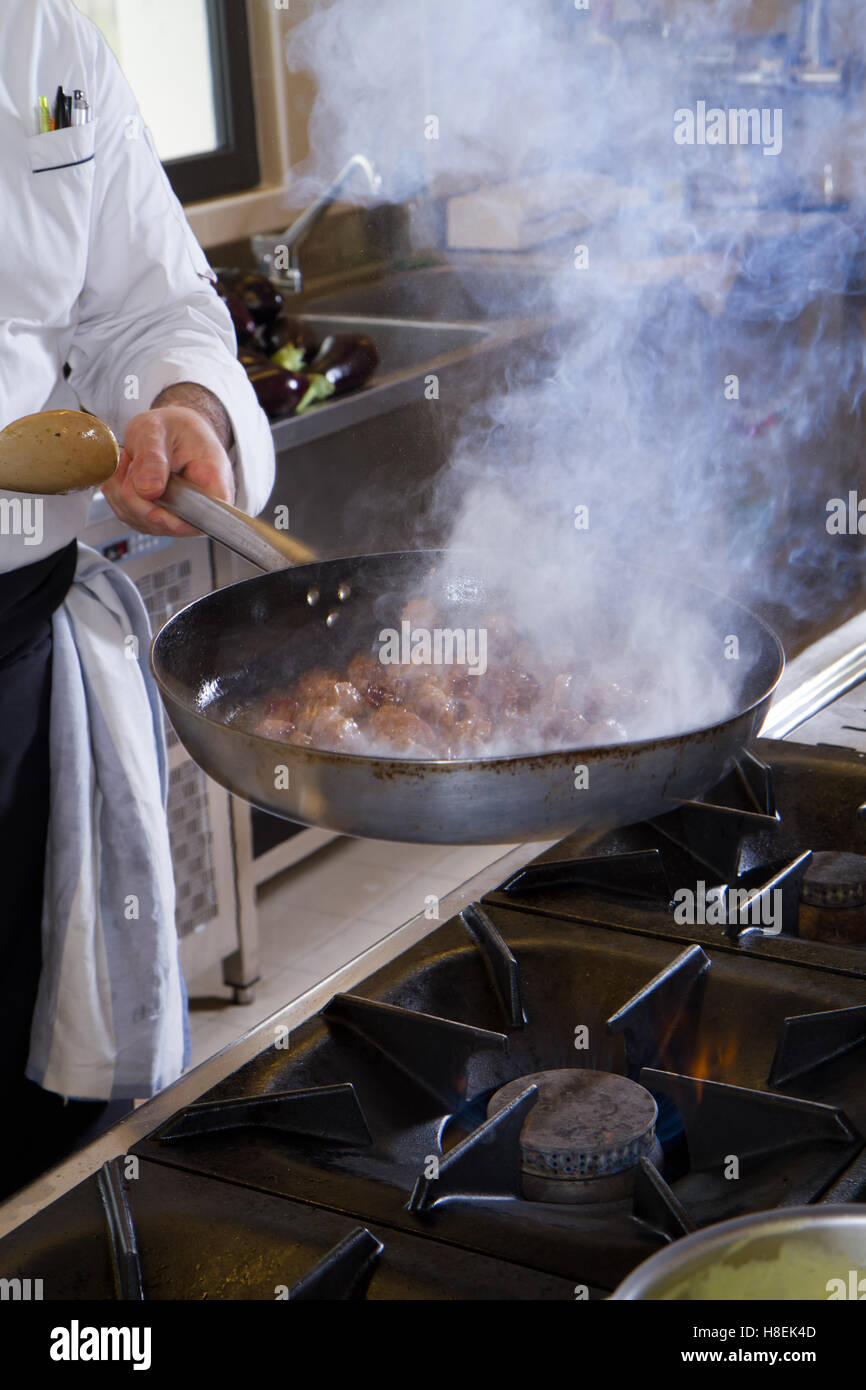 cook preparing food in a restaurant kitchen Stock Photo - Alamy