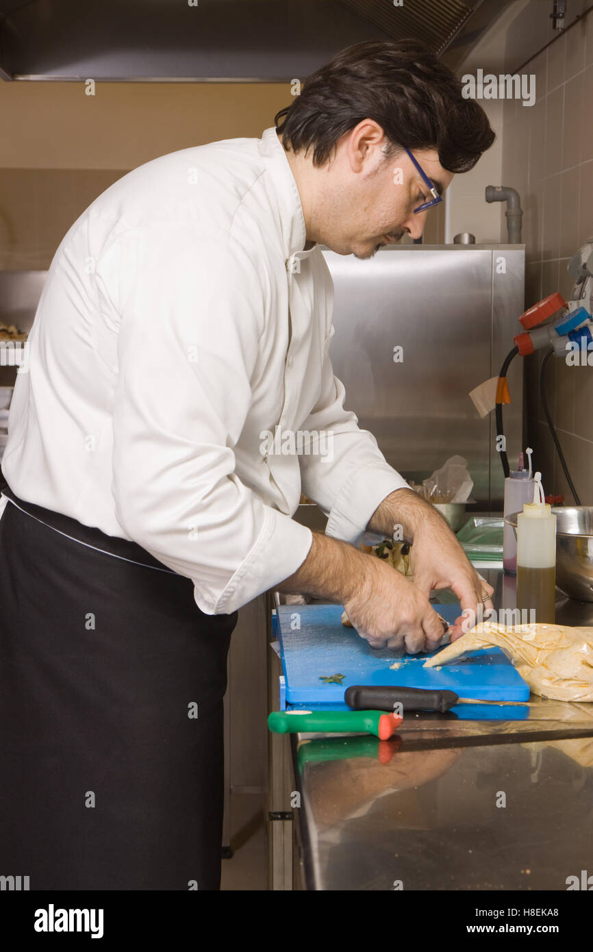 cook working in a kitchen restaurant Stock Photo - Alamy