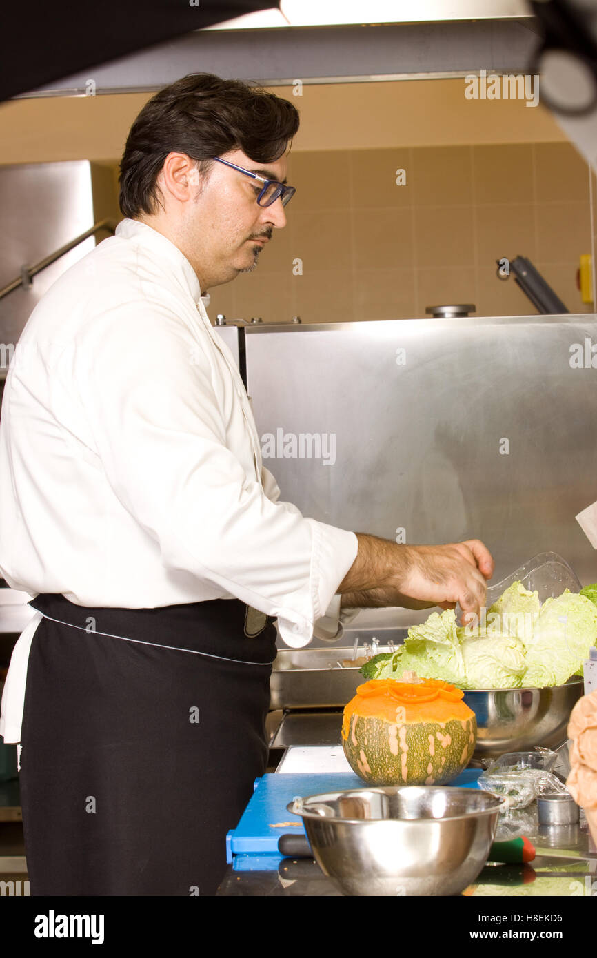cook working in a kitchen restaurant Stock Photo - Alamy
