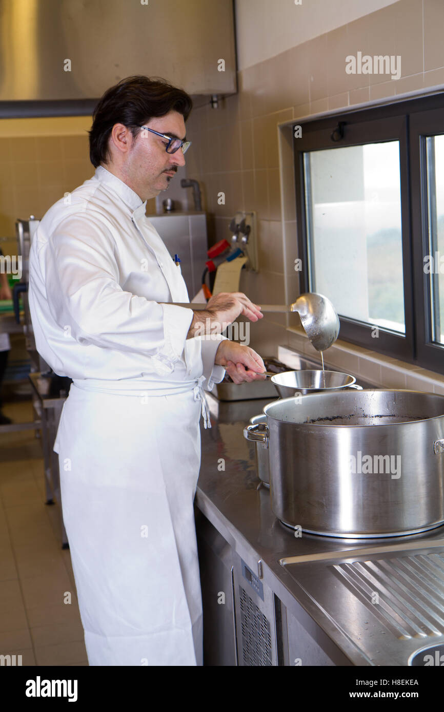 cook working in a kitchen restaurant Stock Photo - Alamy