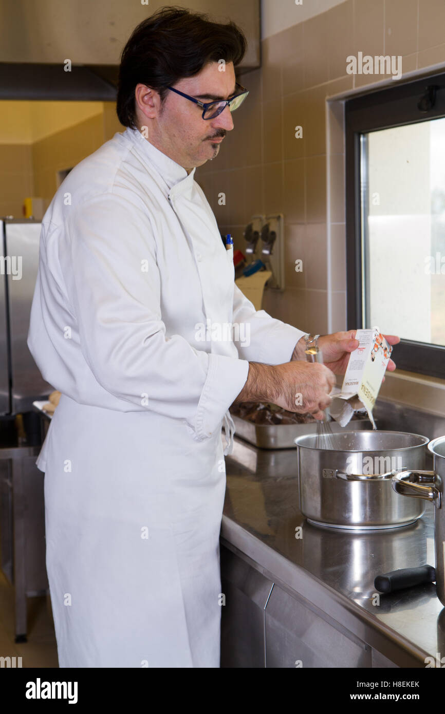 cook working in a kitchen restaurant Stock Photo - Alamy
