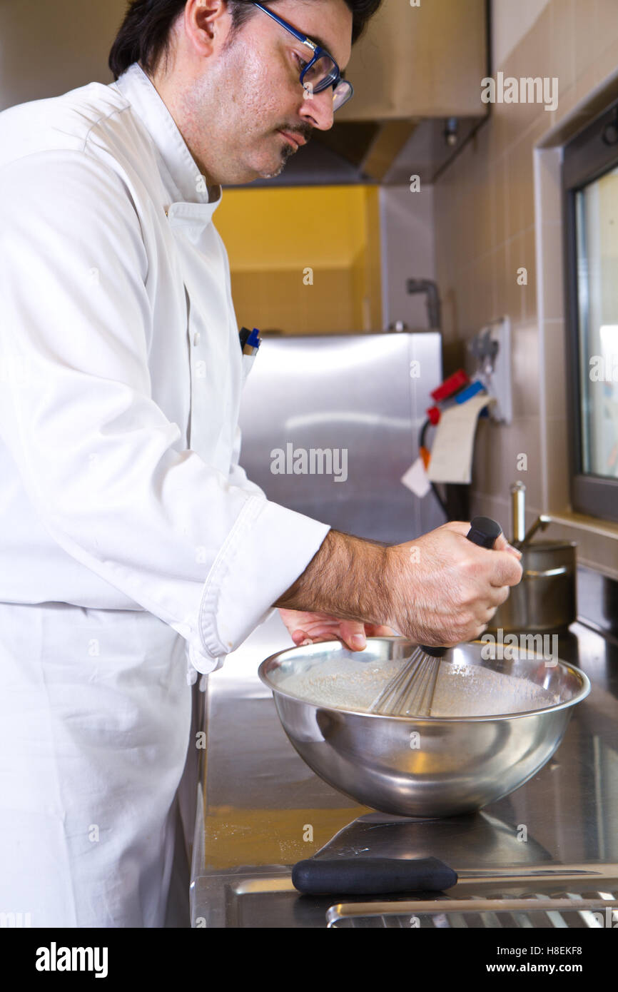 cook working in a kitchen restaurant Stock Photo - Alamy
