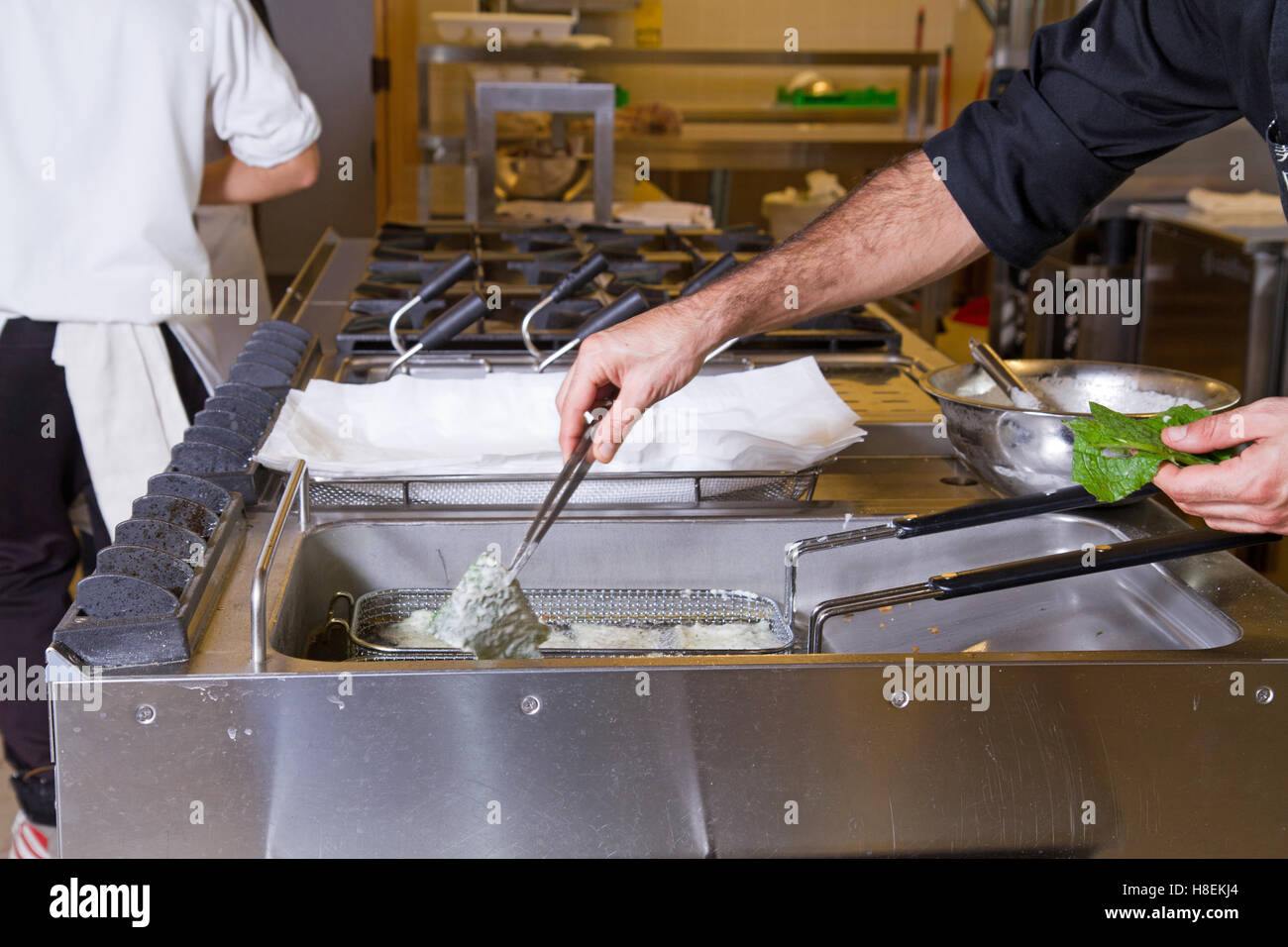 cook at work in a kitchen restaurant Stock Photo - Alamy