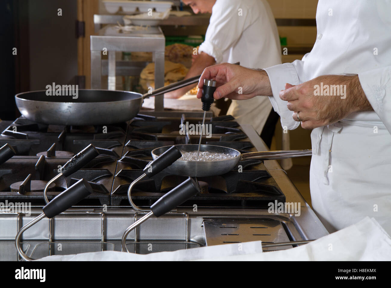 cook at work in a kitchen restaurant Stock Photo - Alamy