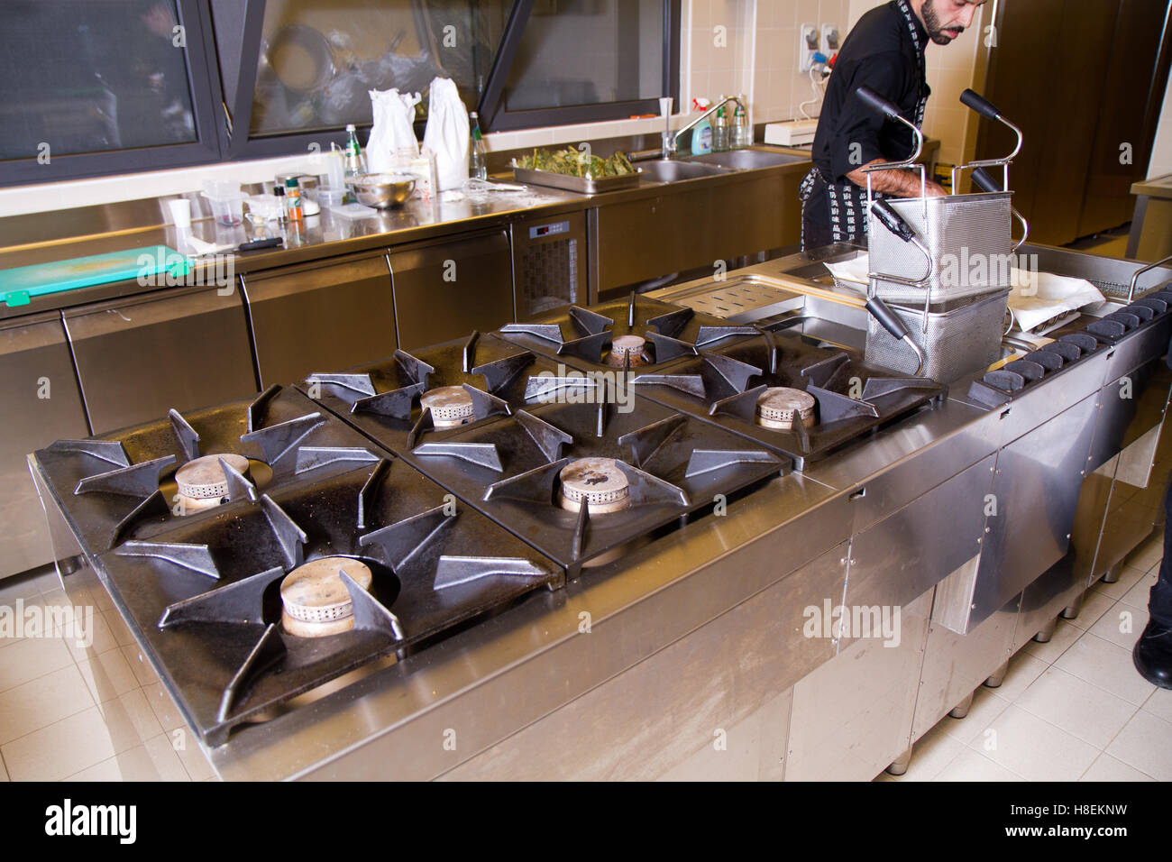 cook at work in a kitchen restaurant Stock Photo - Alamy