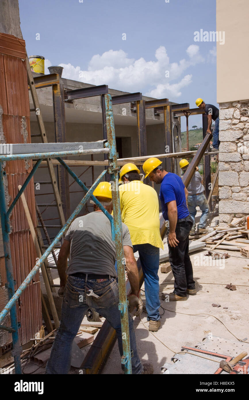 bricklayer working in a building site Stock Photo - Alamy