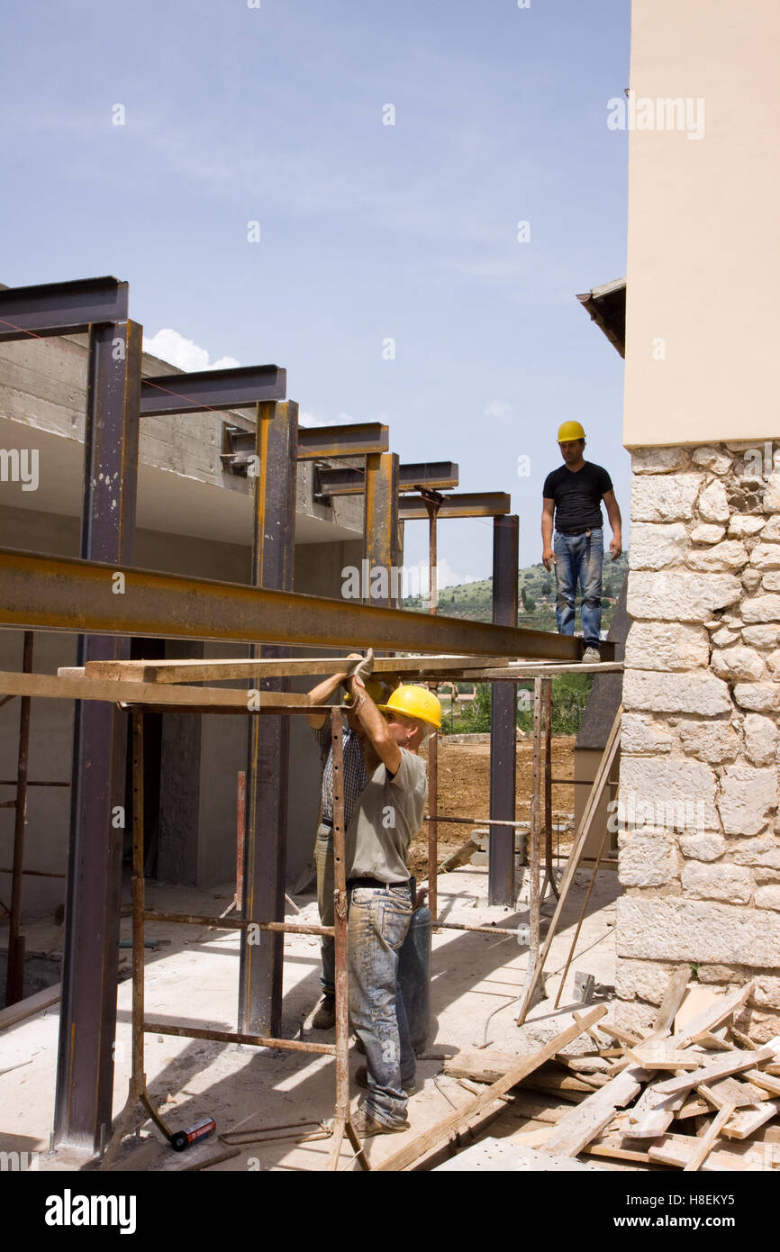 bricklayers working in a building site Stock Photo - Alamy