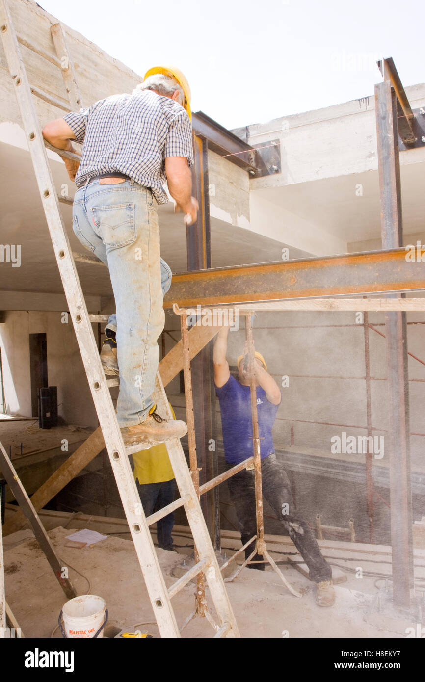 bricklayers working in a building site Stock Photo - Alamy