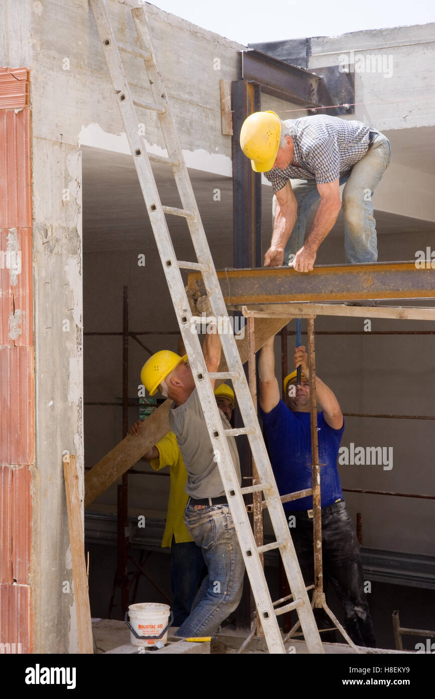 bricklayers working in a building site Stock Photo - Alamy