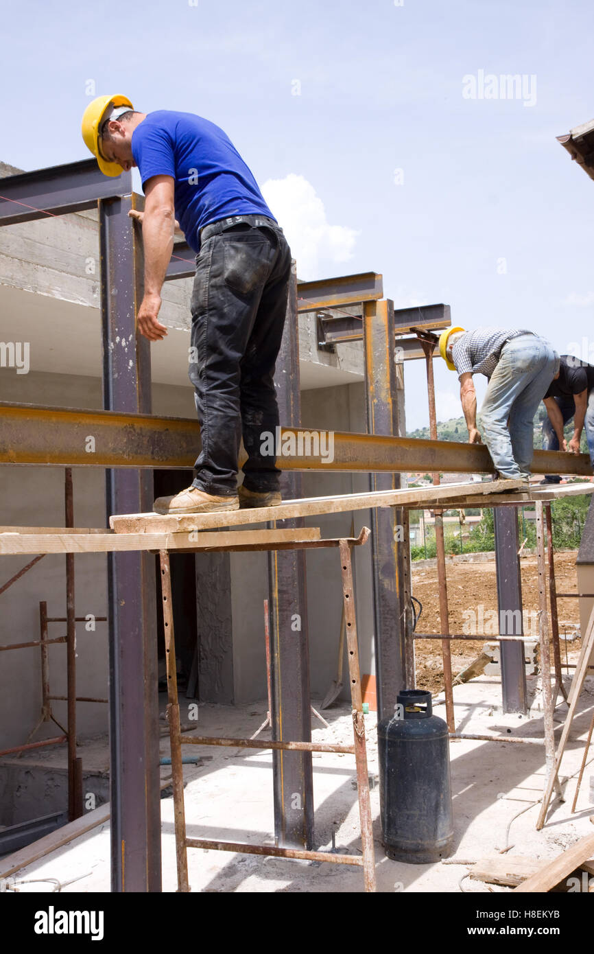 bricklayers working in a building site Stock Photo - Alamy